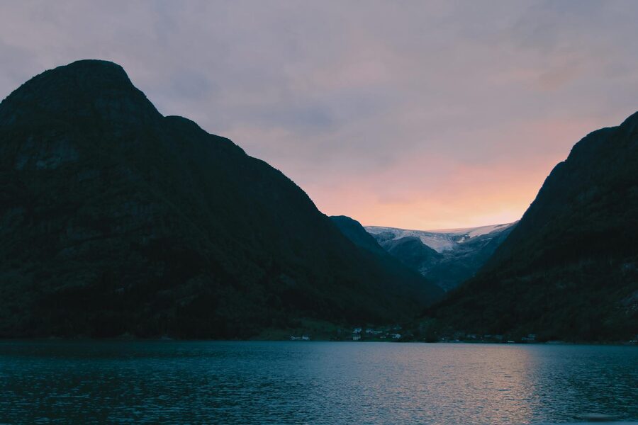 Fjord at sunset with dramatic mountain silhouettes