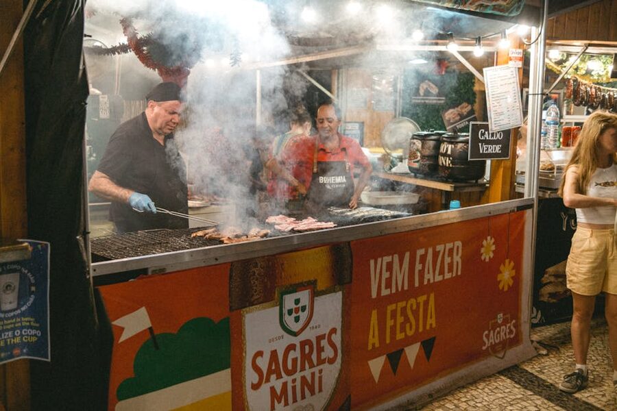 Lisbon street food vendors grilling meats night market