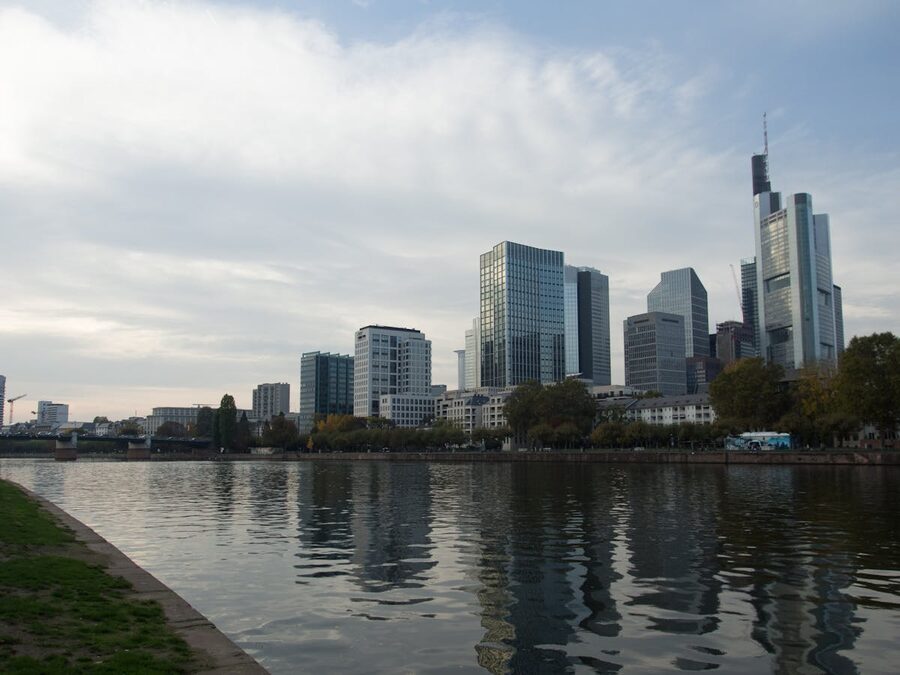 Modern skyscrapers of Frankfurt reflecting in the Main River at dusk