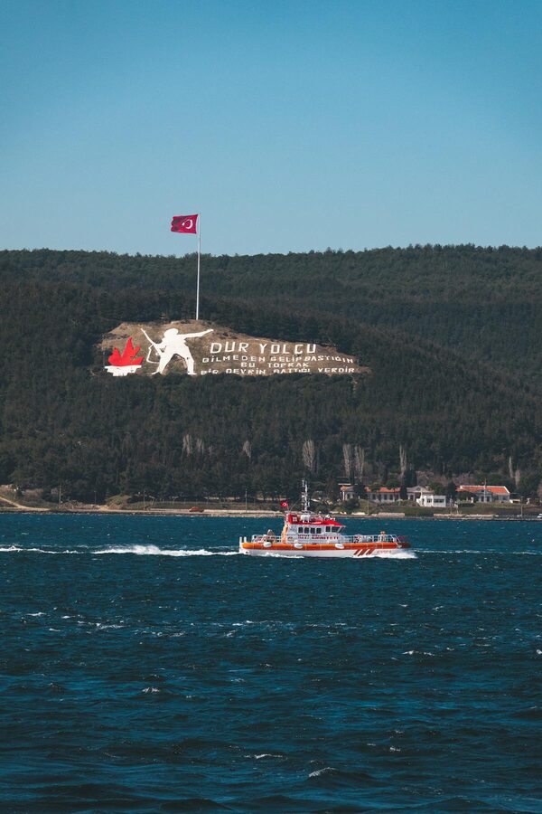 Ferry crossing the Dardanelles strait with Canakkale Martyrs Memorial visible