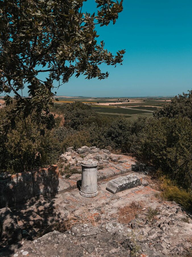 Troy archaeological site surrounded by green countryside under blue sky