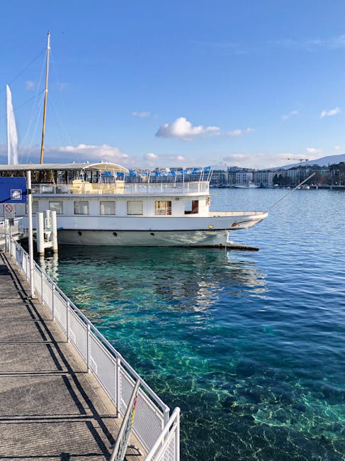 A boat docked at Geneva harbour with clear blue water and sunny skies