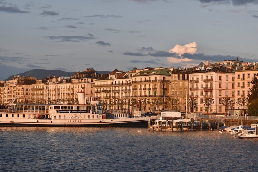 Geneva waterfront with historic architecture bathed in warm sunset light