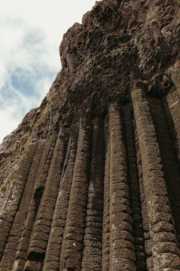 Basalt columns at Giants Causeway with Northern Ireland coastline