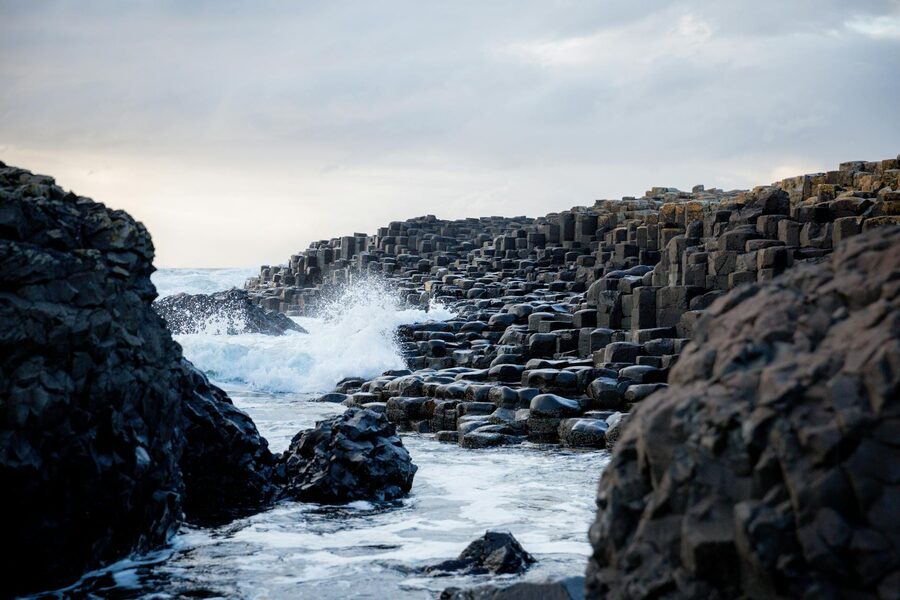 Waves crashing against basalt columns at Giants Causeway Northern Ireland