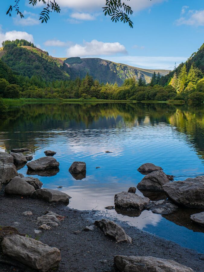 Upper lake at Glendalough with green trees and clear sky