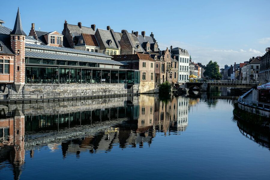 Historic buildings reflected in Ghent canal at Graslei