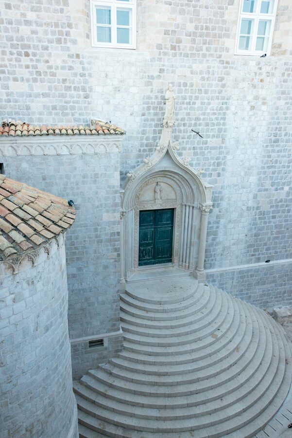 Stone monastery entrance with curved steps in Dubrovnik