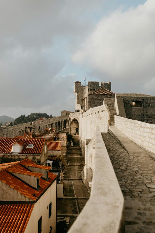 Narrow pathway between stone walls to medieval fortress