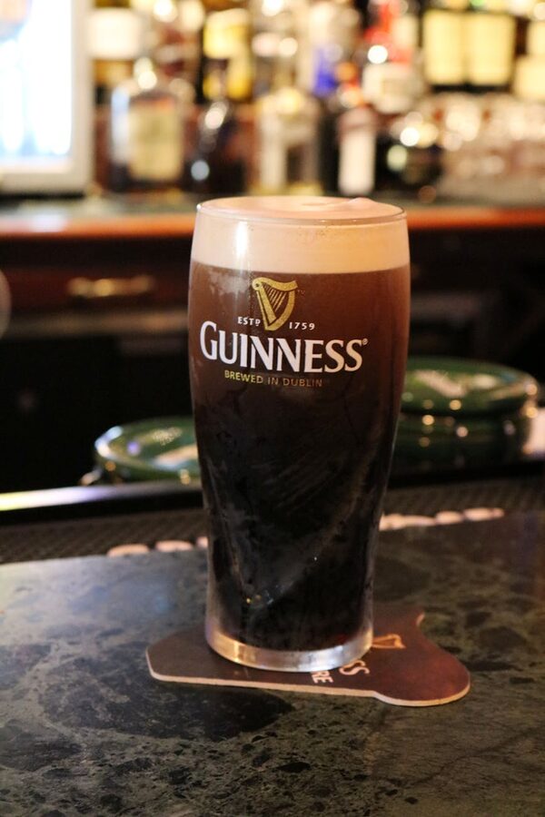 Freshly poured pint of Guinness on a bar counter