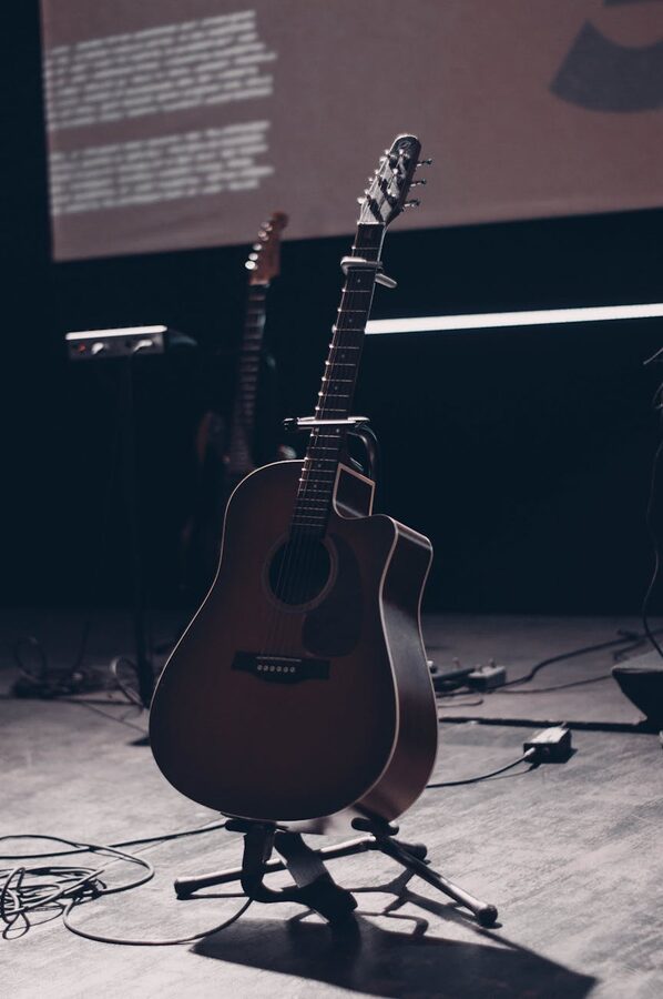 Acoustic guitar in spotlight on an empty stage