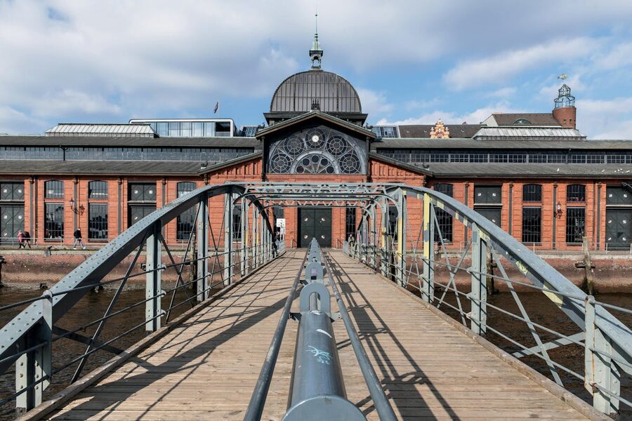 Historic Fish Auction Hall in Hamburg with footbridge under a clear sky