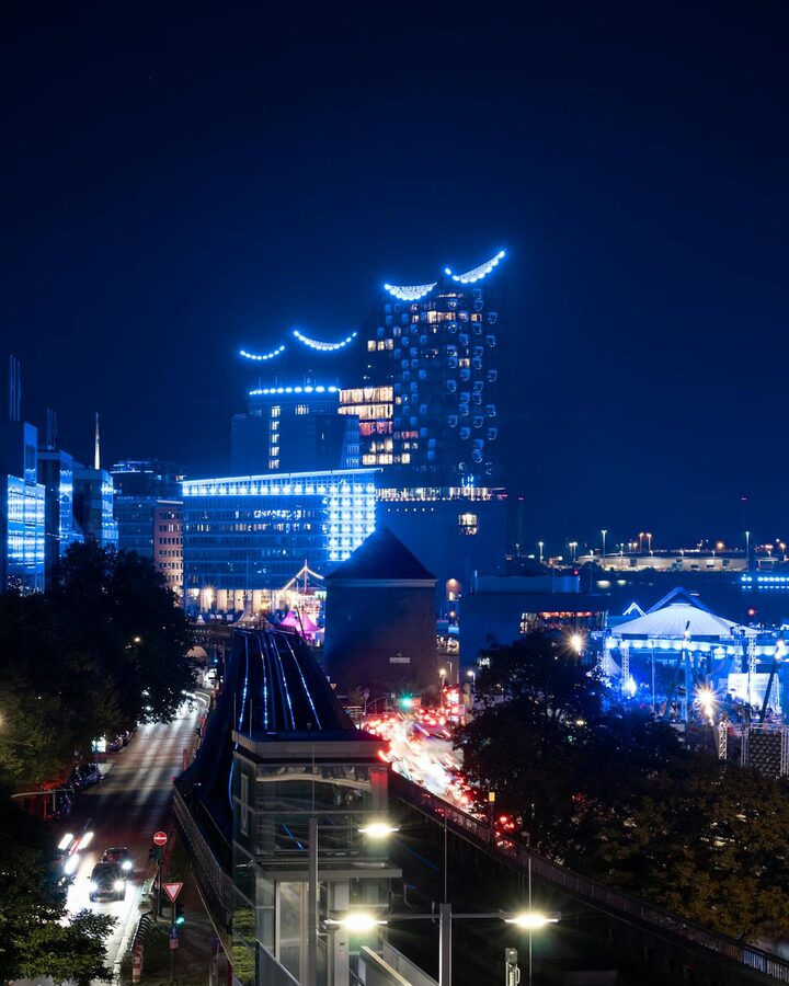 Hamburg harbor at night showing Elbphilharmonie and city lights