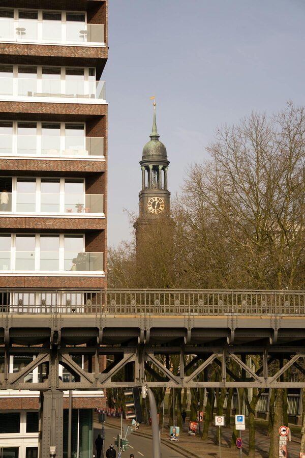 Street view with St. Michael's Church clock tower and modern architecture in Hamburg