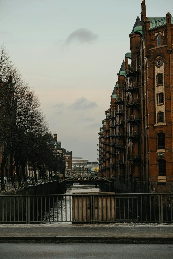 Historic brick warehouses lining a canal in Hamburg Speicherstadt at dusk