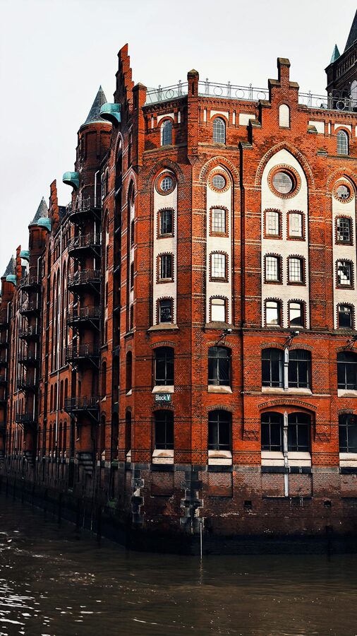 Speicherstadt building reflecting in canal water in Hamburg