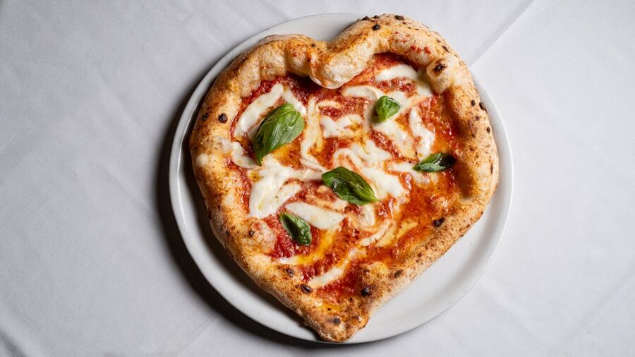 Heart-shaped pizza with basil