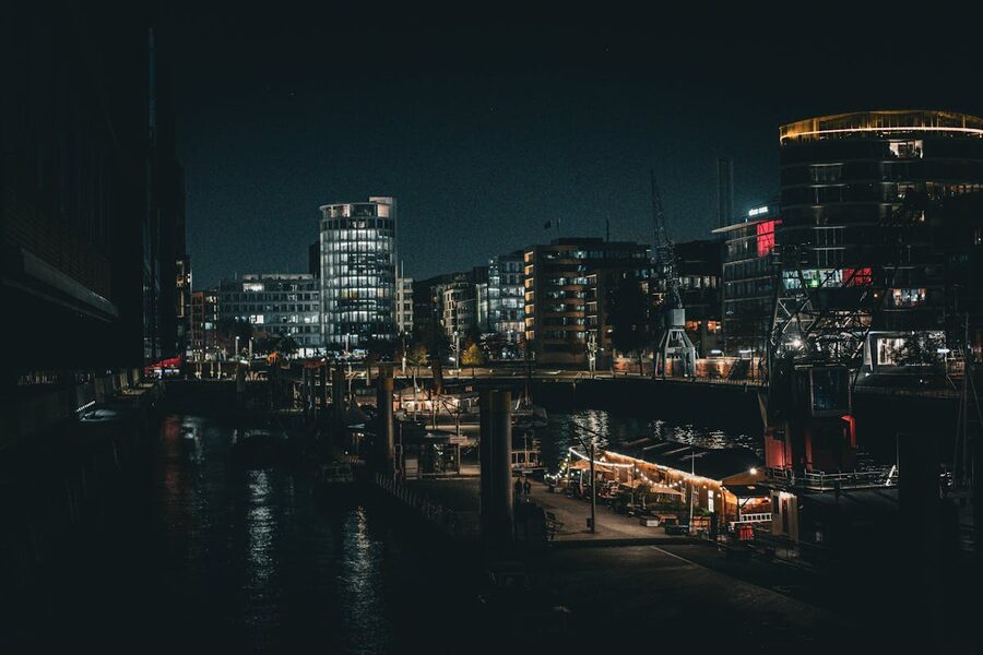 Hamburg port at night with city lights reflecting on the water