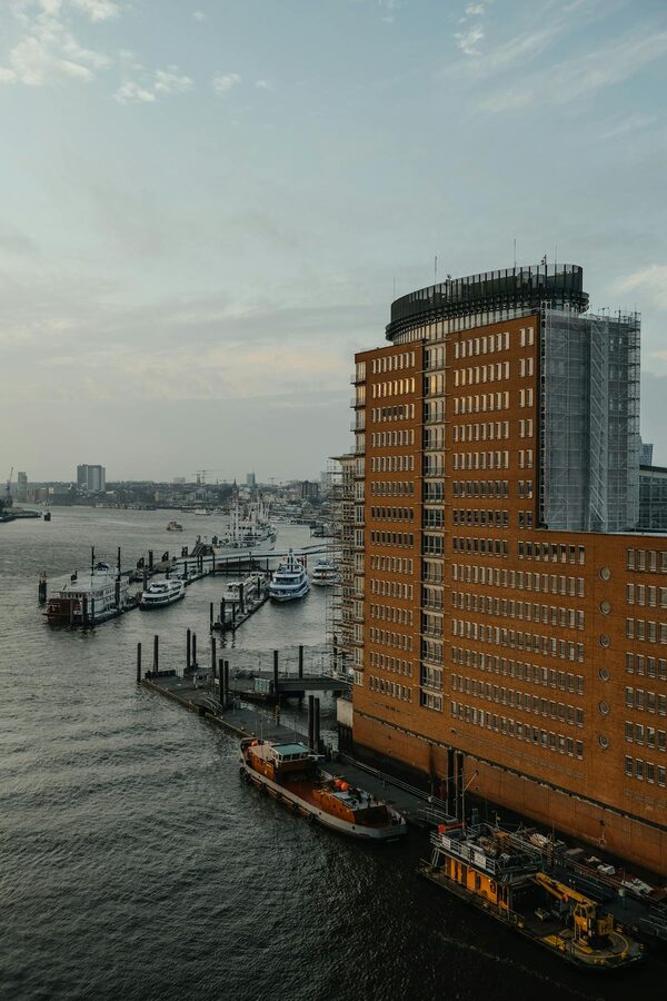 Aerial view of Hamburg harbor at sunset with boats and city skyline