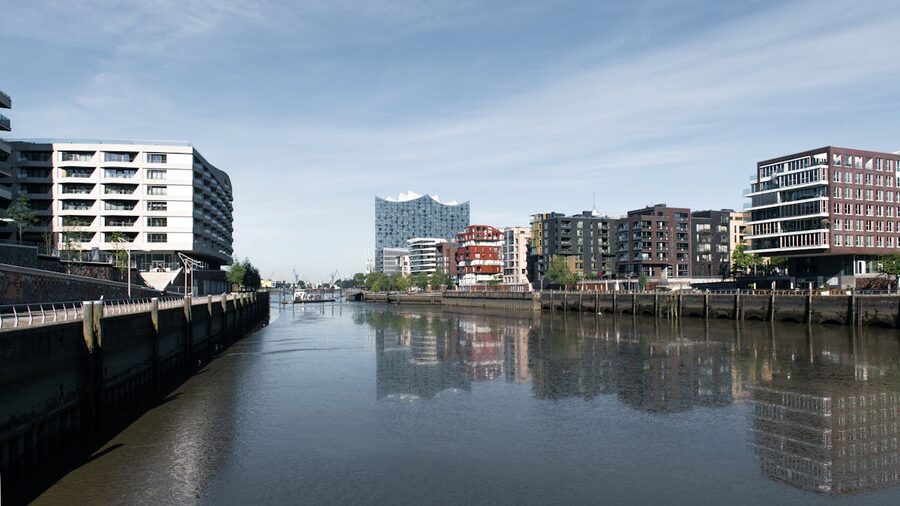 Modern architectural facades lining a canal in Hamburg's HafenCity