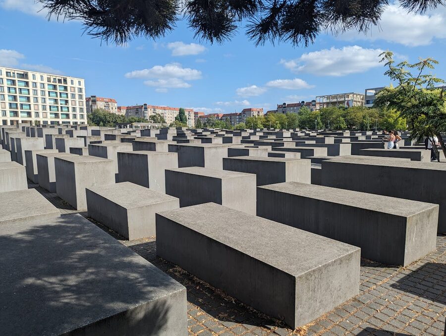 Holocaust Memorial stelae under a bright blue Berlin sky