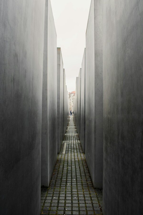 Narrow alley between tall concrete stelae at the Holocaust Memorial in Berlin