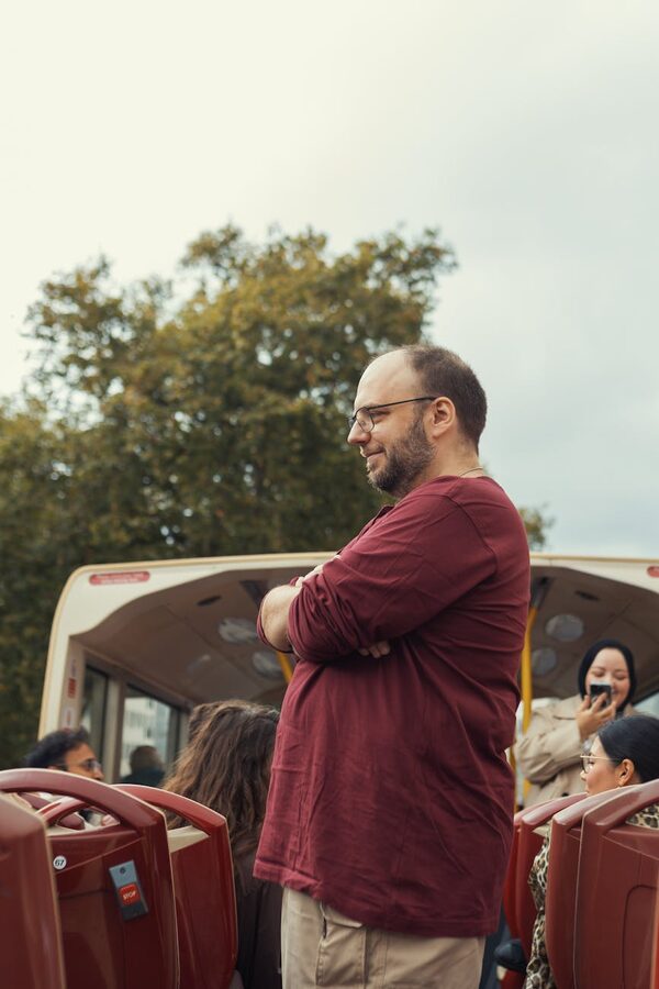 Man standing on open-top tour bus