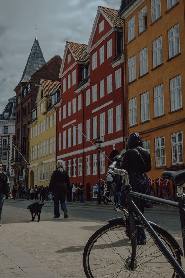 Copenhagen street scene with bright buildings, people, and bicycles
