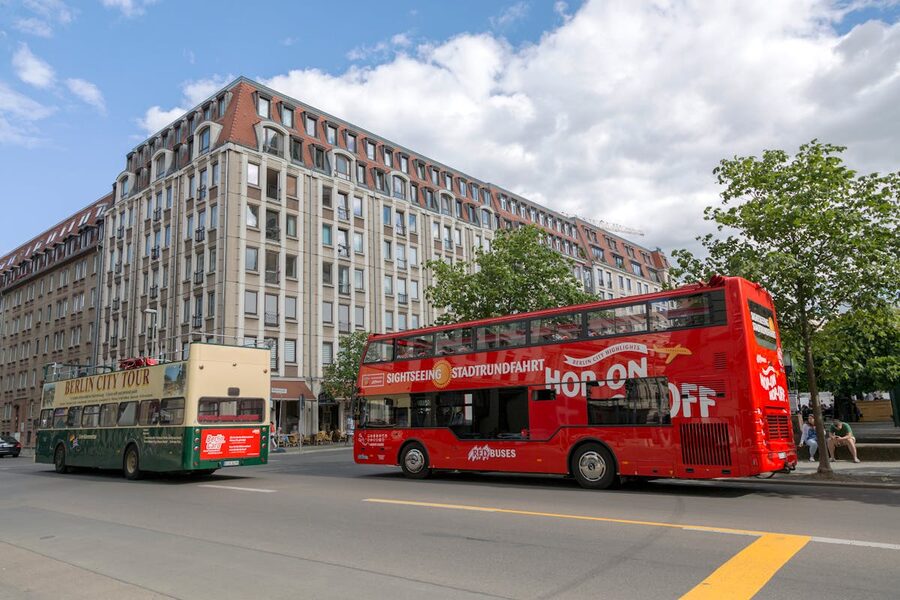 Sightseeing buses near a historic building in Berlin on a clear day
