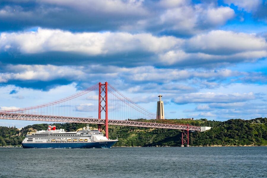 Cruise ship on Tagus River under 25 de Abril Bridge Lisbon