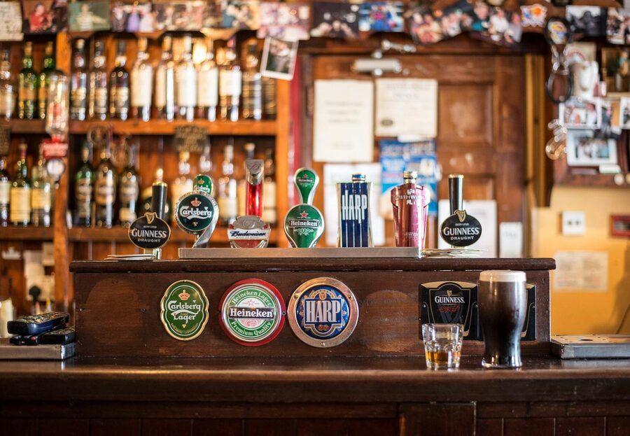 Interior of a traditional Irish pub with beer taps and wooden bar