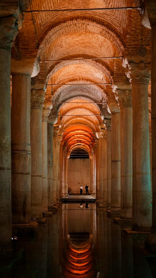 Ancient Basilica Cistern with illuminated arches reflecting in the water
