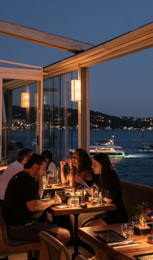 Group enjoying dinner with Bosphorus view in Istanbul