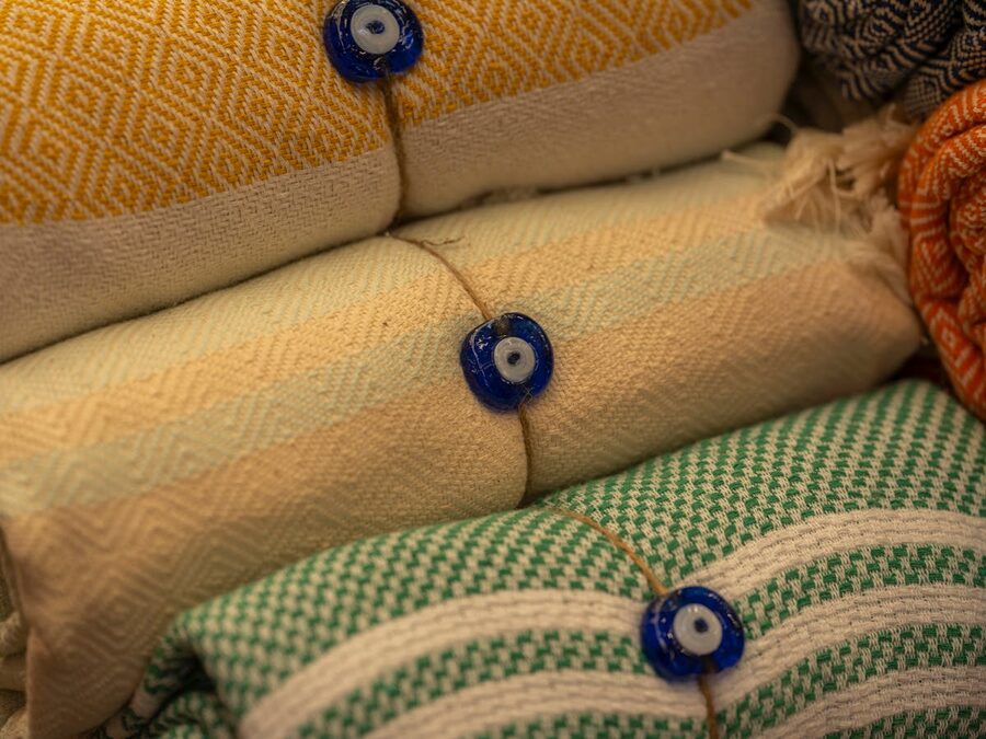 Colourful towels with decorative evil eye beads