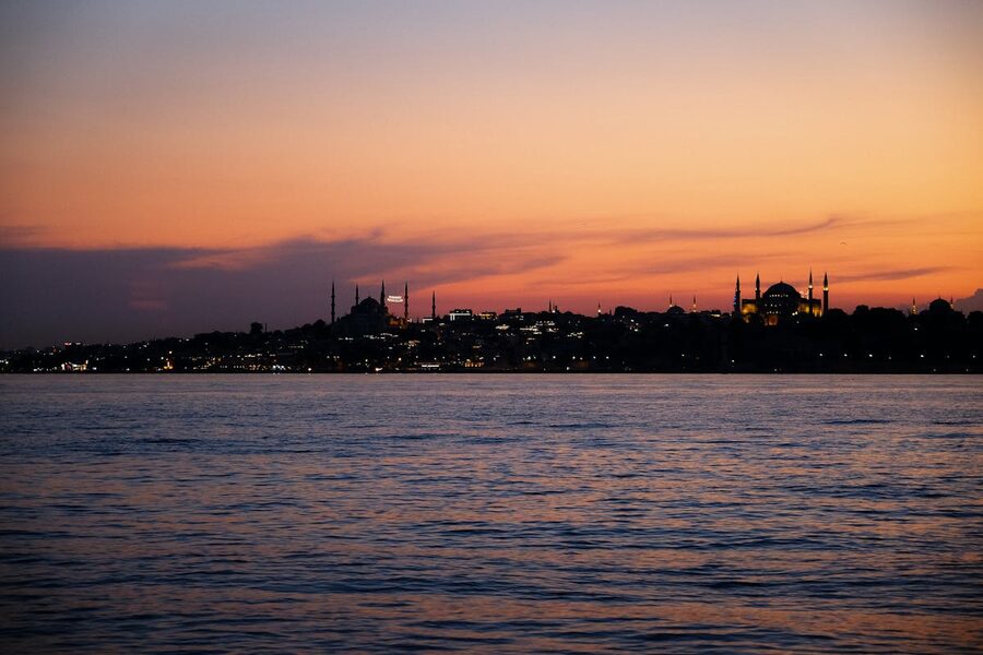 Istanbul skyline over water at twilight with mosques silhouetted