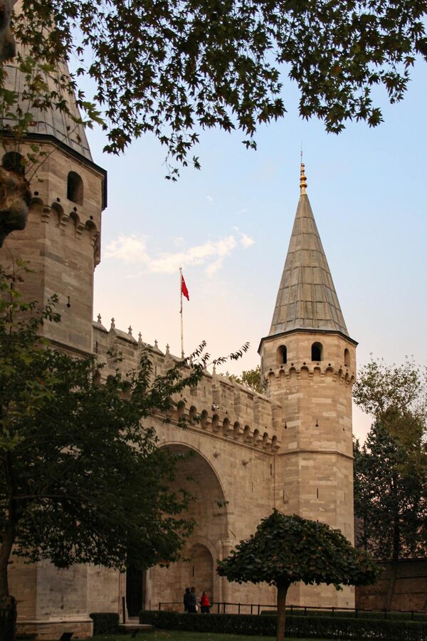 Topkapi Palace entrance with architectural towers and trees in Istanbul