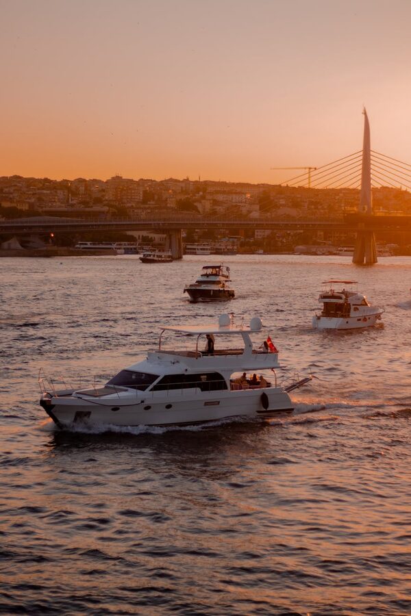Boats near the Halic Metro Bridge at sunset in Istanbul