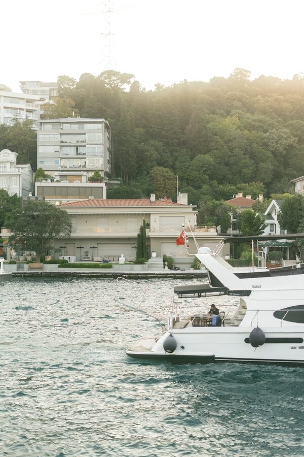 White yacht passing historic buildings on the Bosphorus