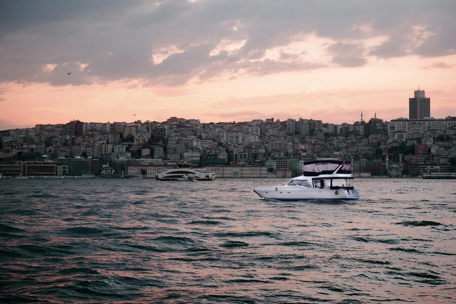 Yacht on the Bosphorus at dusk with Istanbul cityscape