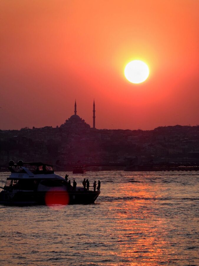 Yacht silhouette against Istanbul sunset skyline