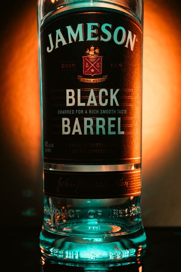 Close-up of Jameson Black Barrel bottle with warm glowing background