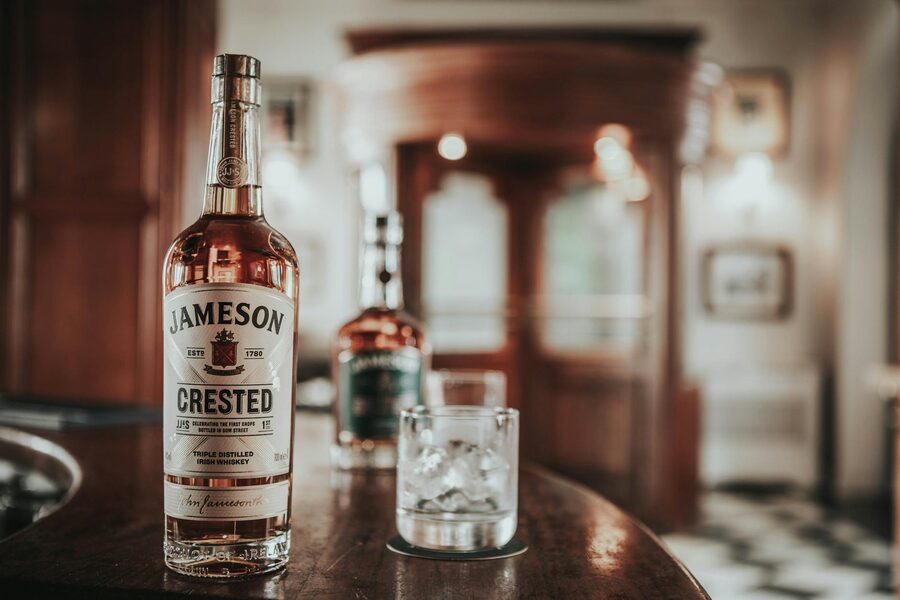 Jameson Crested whiskey bottle in a classic Dublin bar setting