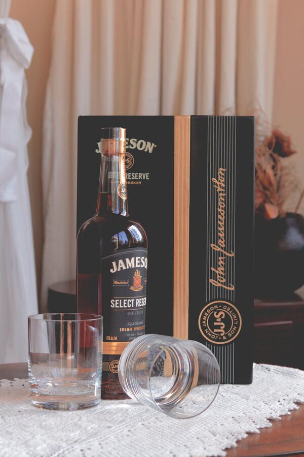 Jameson Select Reserve whiskey bottle with glasses arranged on a table
