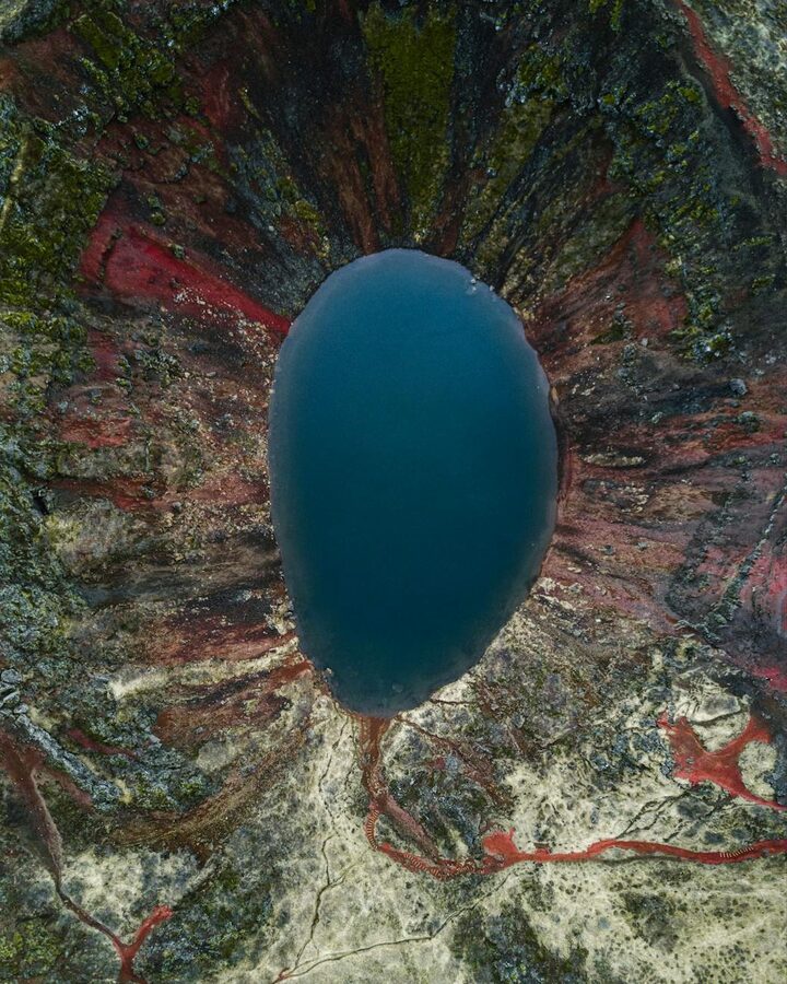 Aerial view of Kerid crater lake surrounded by colorful volcanic rocks