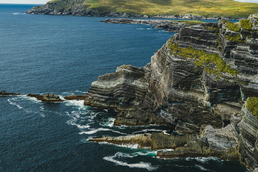 Aerial view of rocky Kerry cliffs with blue ocean