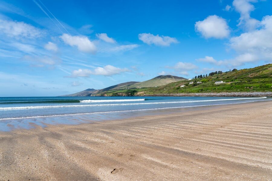 Kerry beach with rolling waves and green hills