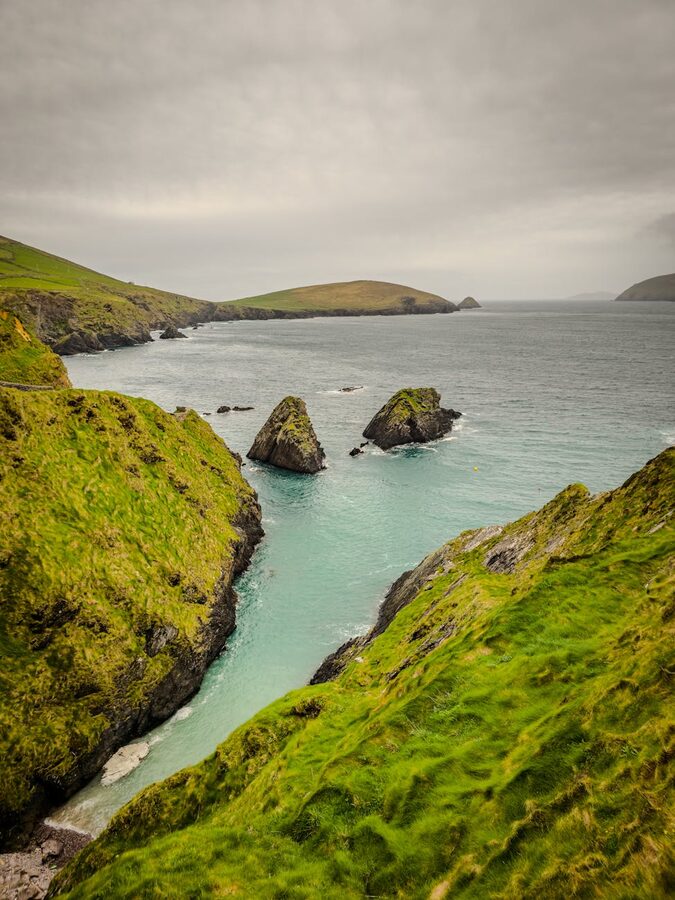Cliffs and sea stacks at Dunquin with green hills