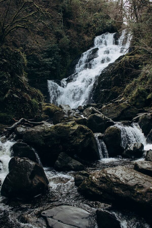Waterfall surrounded by green vegetation in Killarney
