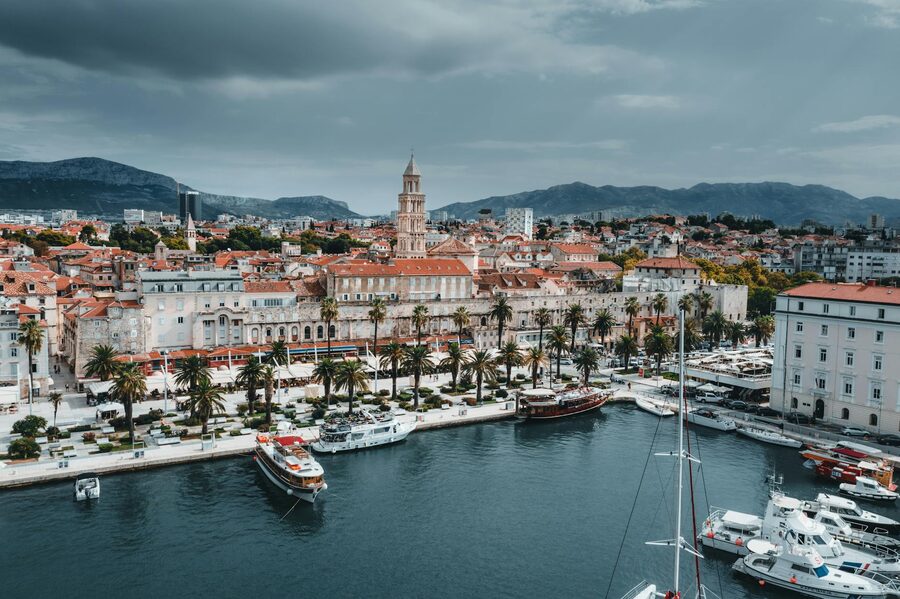 Yachts docked at Croatian waterfront with city buildings