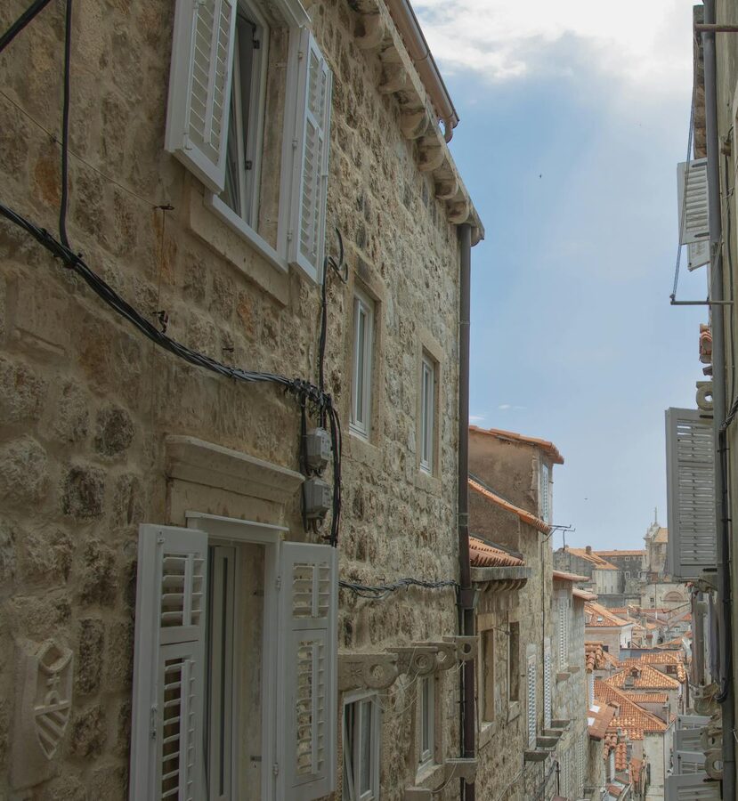 Stone houses with window shutters on town street